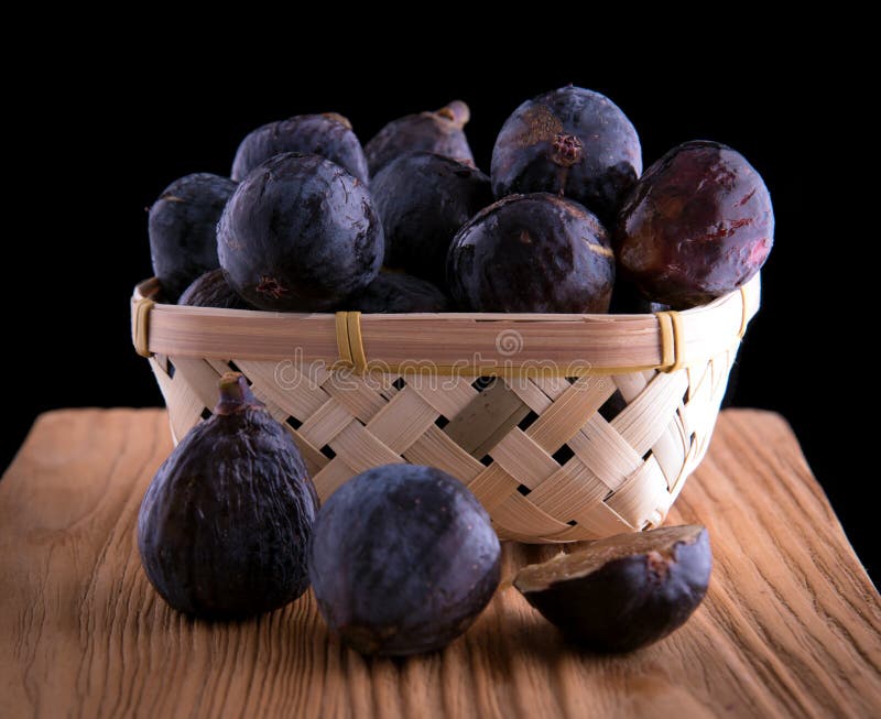 Fresh Purple Figs in Wicker Light Basket on the Rustic Board. Cuted ...