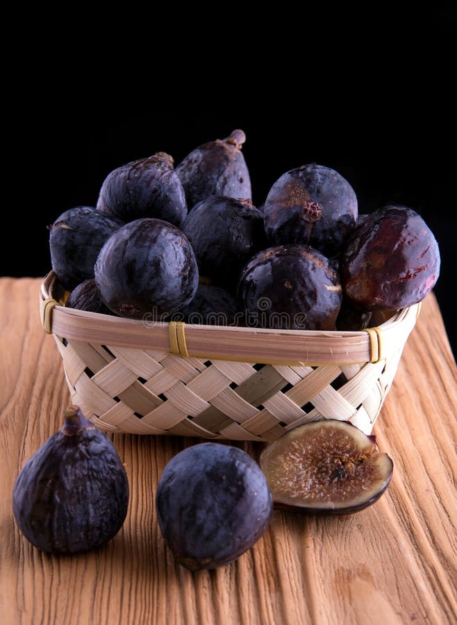 Fresh Purple Figs in Wicker Light Basket on the Rustic Board. Cuted ...