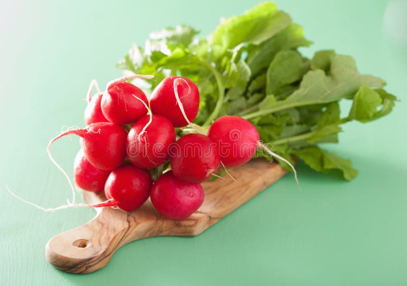 Fresh Radish with Leaves Over Green Background Stock Photo - Image of ...