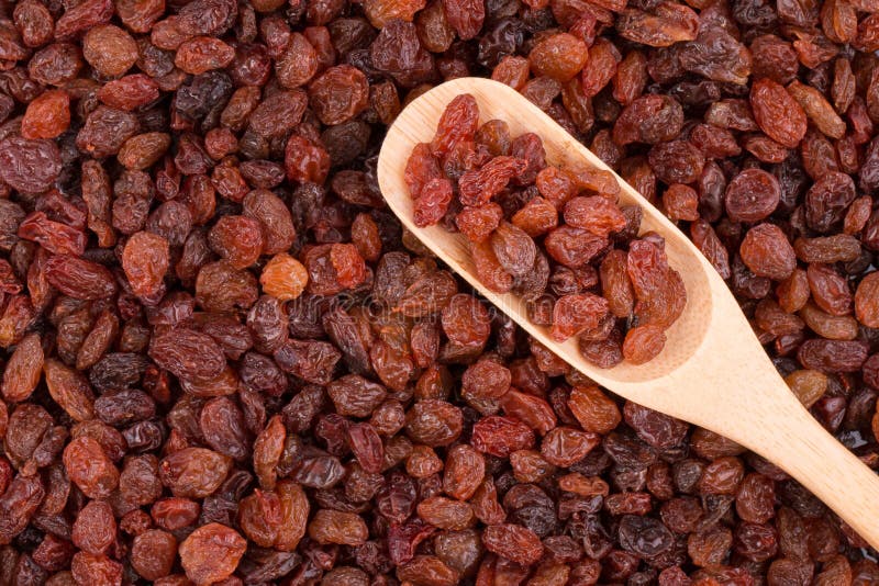 Raisins in a wooden spoon stock image. Image of pile - 109616055