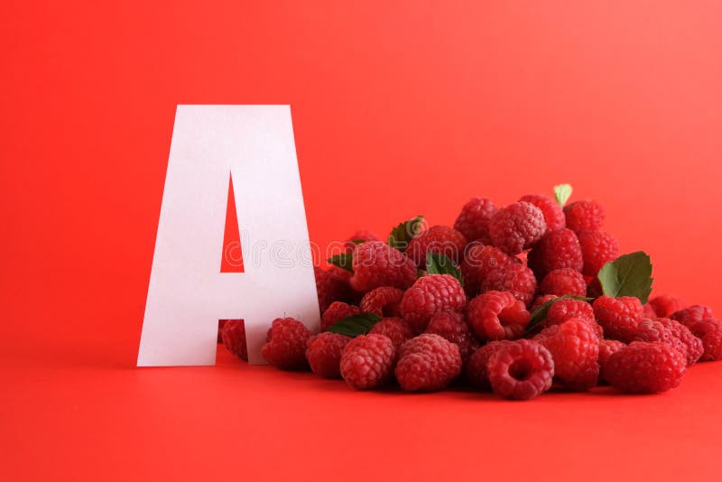 Fresh Raspberries with Mint Leaves on a Red Background Stock Photo ...