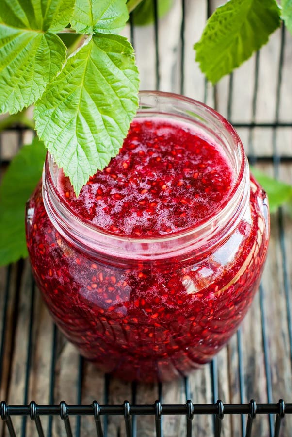 Fresh Raspberrys Jam in an Open Jar with Leaves Stock Image - Image of ...