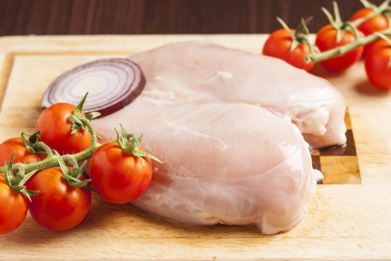 Fresh Raw Chicken Breast with Cocktail Tomato Stock Image - Image of ...