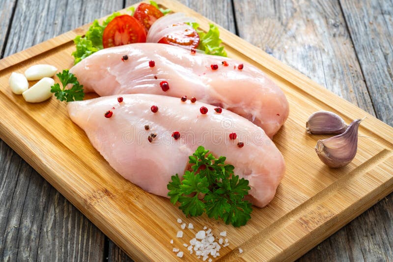 Fresh Raw Chicken Breasts on Cutting Board with Spices on Wooden ...