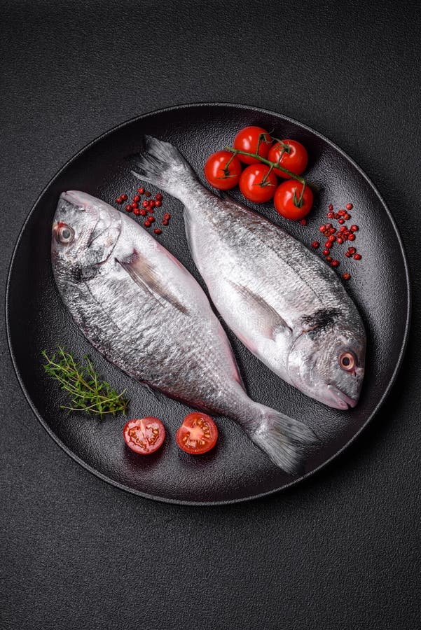 Fresh Raw Dorada Fish with Salt, Spices and Herbs Stock Photo - Image ...