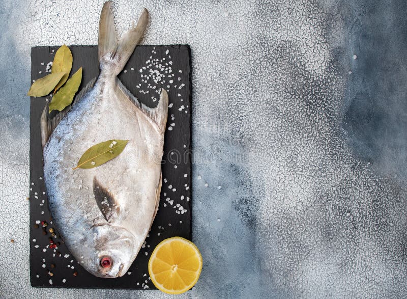 Fresh Raw Fish Pompano and Spice Ingredients on Table Stock Image ...
