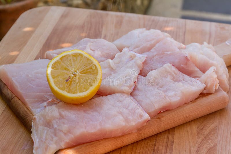 Fresh Raw Fish Slices with Lemon on Cutting Board Stock Image - Image ...