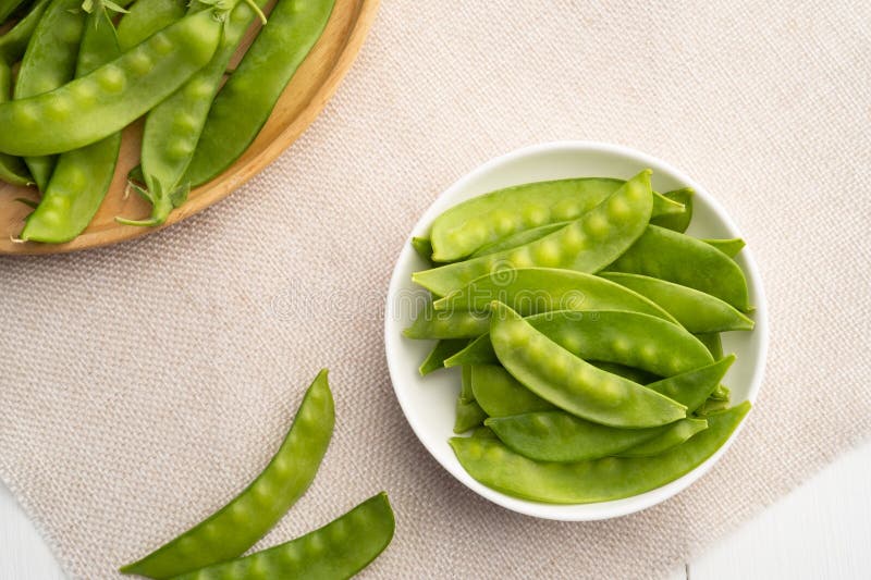 Fresh Raw Flat Green Peas or Snow Peas in White Plate. Stock Photo ...