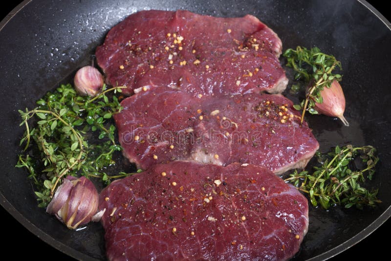 Fresh Raw Meat with Thyme Fried on Black Frying Pan Stock Image - Image ...