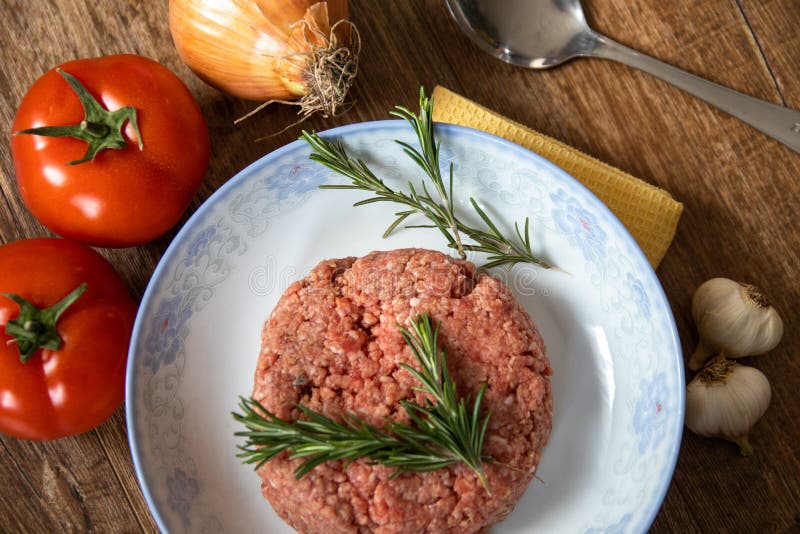 Fresh Raw Minced Meat with Rosemary on a Plate and Tomato Stock Image ... Fresh Raw Minced Meat with Rosemary on a Plate and Tomato Stock Image ...