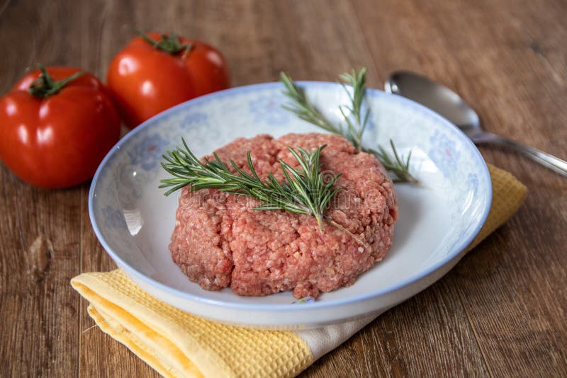 Fresh Raw Minced Meat with Rosemary on a Plate and Tomato Stock Image ... Fresh Raw Minced Meat with Rosemary on a Plate and Tomato Stock Image ...