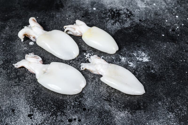 Fresh Raw Mini Cuttlefish on the Table. Black Background. Top View ...