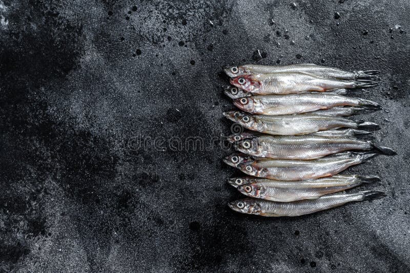 Fresh Raw Sea Small Fish Smelt. Black Background. Top View Stock Photo ...