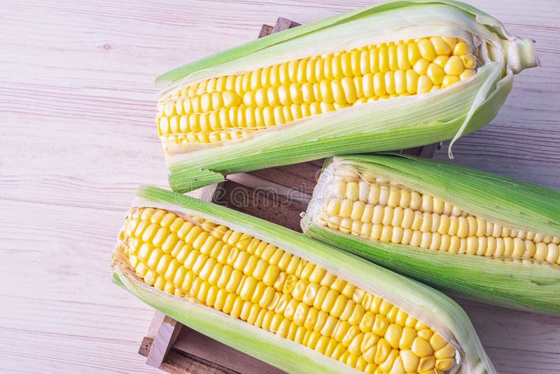 Fresh Raw Sweet Corn on the Cob Kernels Over Wooden Background Stock ...