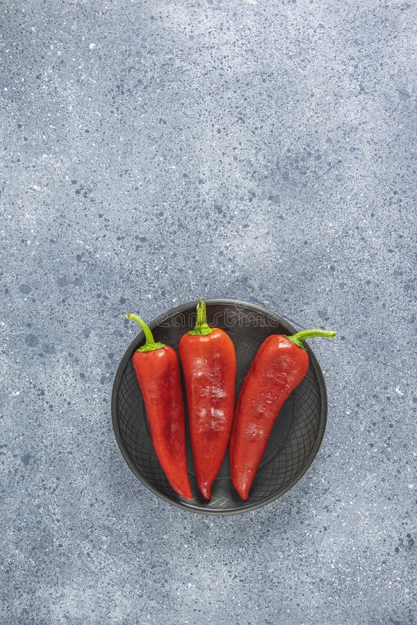Fresh Raw Sweet Red Pepper Kapi with Water Drops in Black Ceramic Plate ...