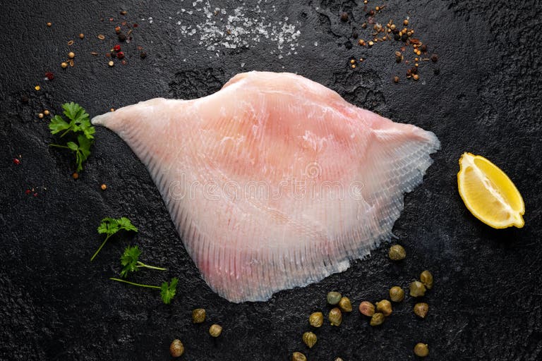 Fresh Ray Wings Fish with Herbs on Rustic Black Background Stock Image ...