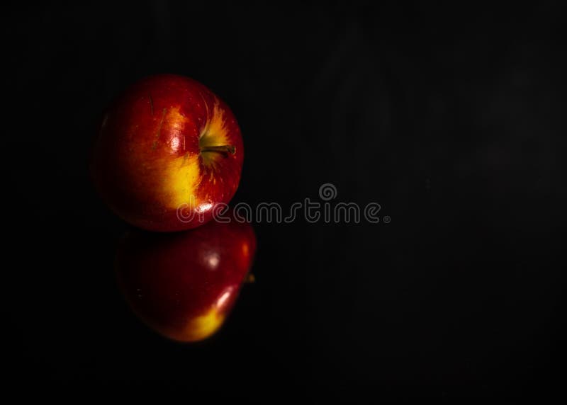 Fresh Red Apple Reflection on Black Mirror Surface. Close Up Stock ...