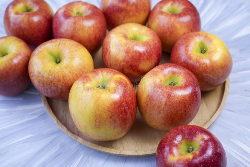 Fresh Red Apple in Wooden Plate on Blue Wooden Background, US. Red Envy ...