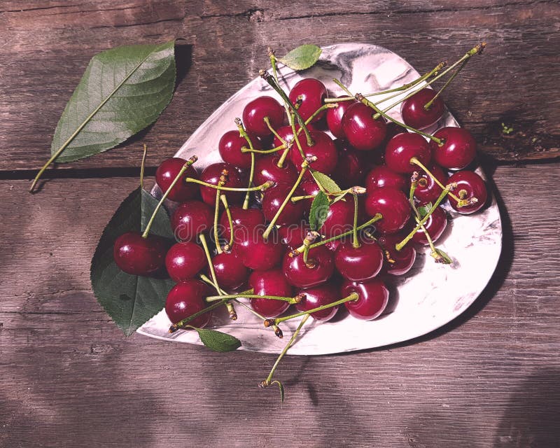 Fresh Red Cherry Fruit in Plate on Wood Table Background Stock Image ...
