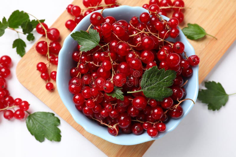 Fresh Red Currants in Bowl and Green Leaves on White Table, Top View ...