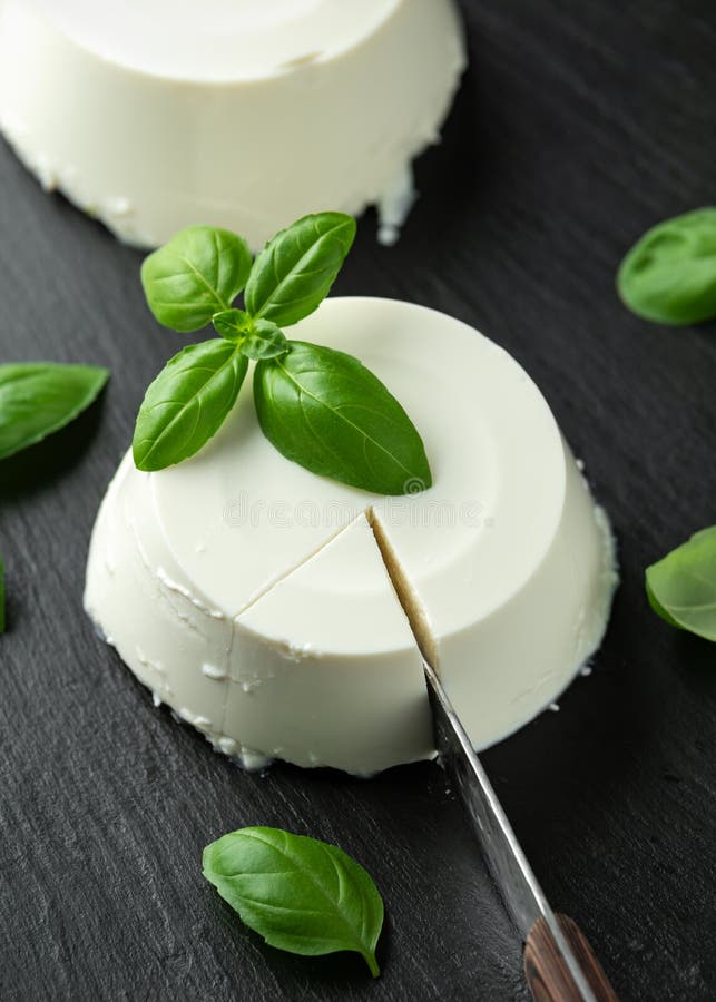 Fresh Ricotta Cheese with Basil Leaf on Black Rustic Table. Selected ...
