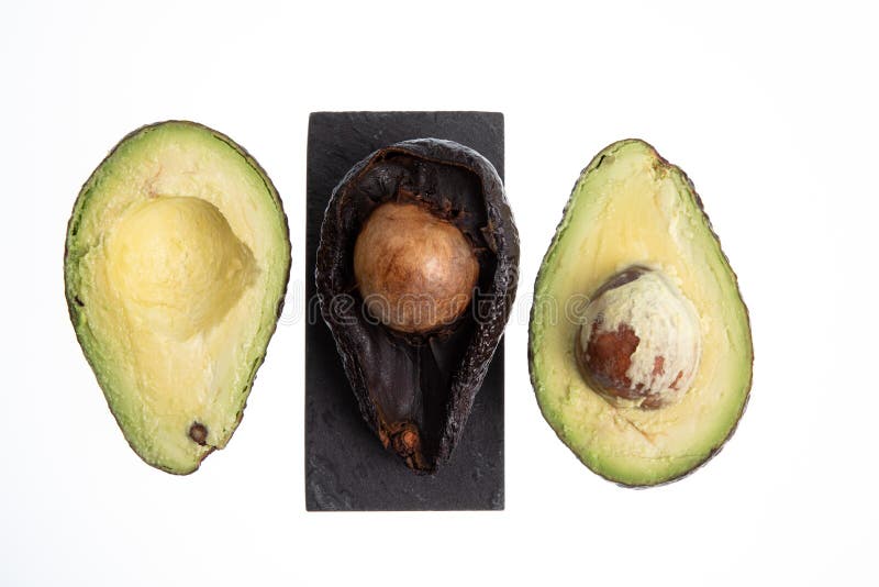 Fresh and Ripe Avocado Next To Rotting Avocado Cut in Half with Seed ...