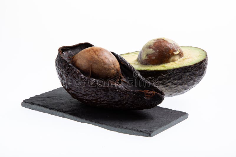 Fresh and Ripe Avocado Next To Rotting Avocado Cut in Half with Seed ...