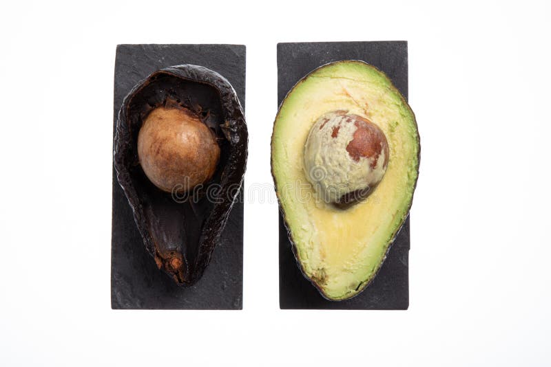Fresh and Ripe Avocado Next To Rotting Avocado Cut in Half with Seed ...