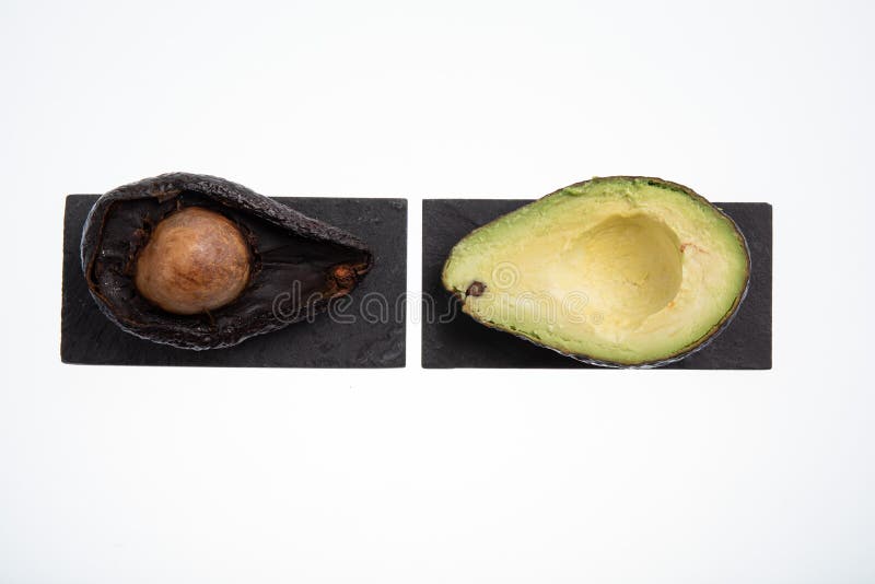 Fresh and Ripe Avocado Next To Rotting Avocado Cut in Half with Seed ...