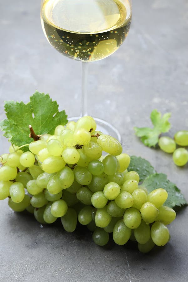 Fresh Ripe Grapes and Glass of Wine on Grey Table Stock Image - Image ...