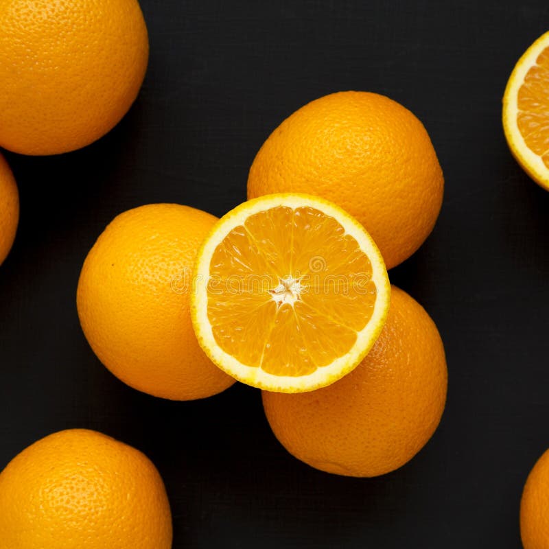 Fresh Ripe Organic Oranges on a Black Surface, Top View. Flat Lay ...