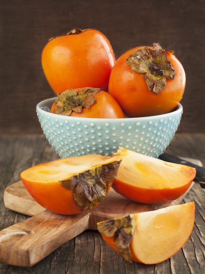 Fresh Ripe Persimmons on a Wooden Table. Stock Image - Image of ripe ...