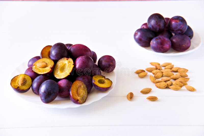 Fresh Ripe Plum Cut in Half in a Plate with Pits. Stock Photo - Image ...
