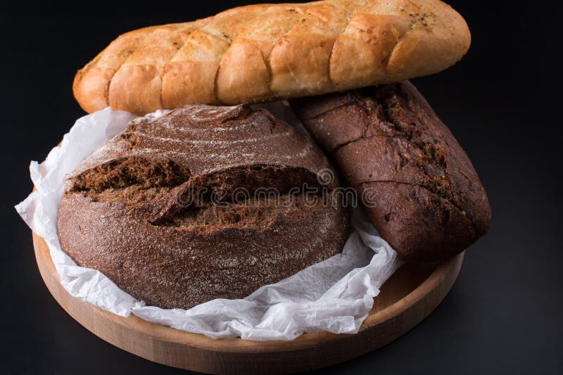 Fresh Round Black Bread with a Crispy Crust, Garlic Baguette White and ...