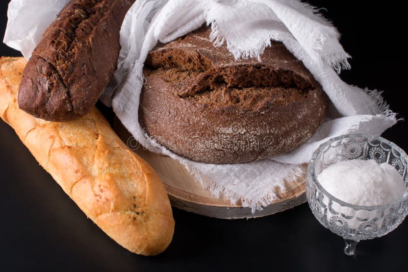 Fresh Round Black Bread with a Crispy Crust, Garlic Baguette White and ...