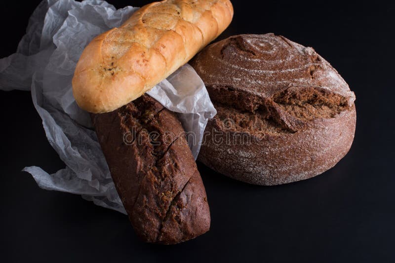 Fresh Round Black Bread with a Crispy Crust, Garlic Baguette White and ...