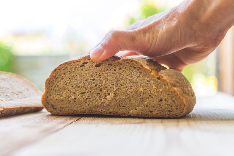 Fresh Rustic Bread in the Morning. Hands of Baker Holding Half Loaf of ...