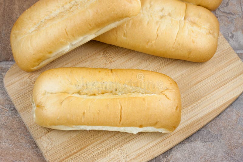 Fresh Sandwich Rolls on a Cutting Board Stock Photo - Image of pile ...