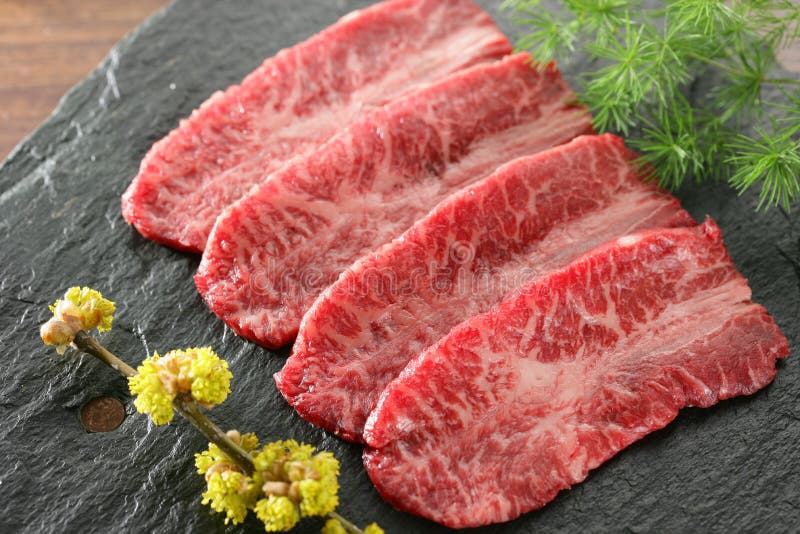 Fresh Sliced Beef on Black Rock Plate with Herbs Stock Photo - Image of ...