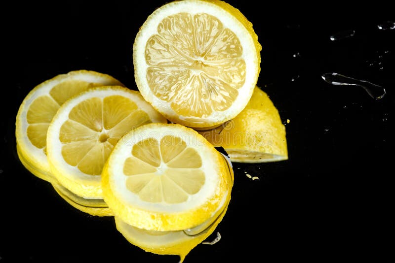 Fresh Sliced Lemon with Water Drops Isolated on Black Stock Image ...