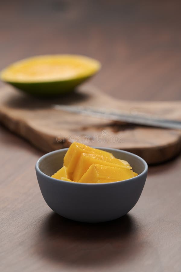 Fresh Sliced Mango in a Ceramic Bowl on Walnut Table Stock Image ...