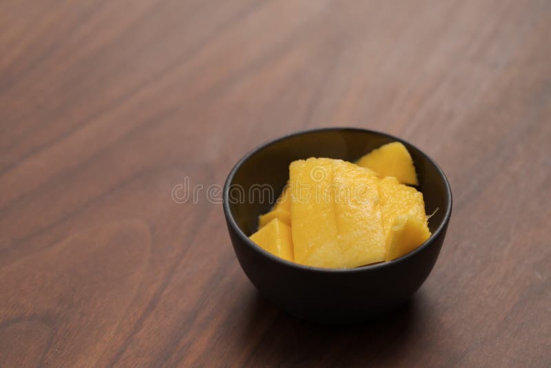 Fresh Sliced Mango in a Ceramic Bowl on Walnut Table Stock Image ...