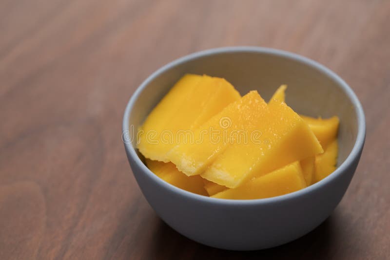Fresh Sliced Mango in a Ceramic Bowl on Walnut Table Stock Image ...