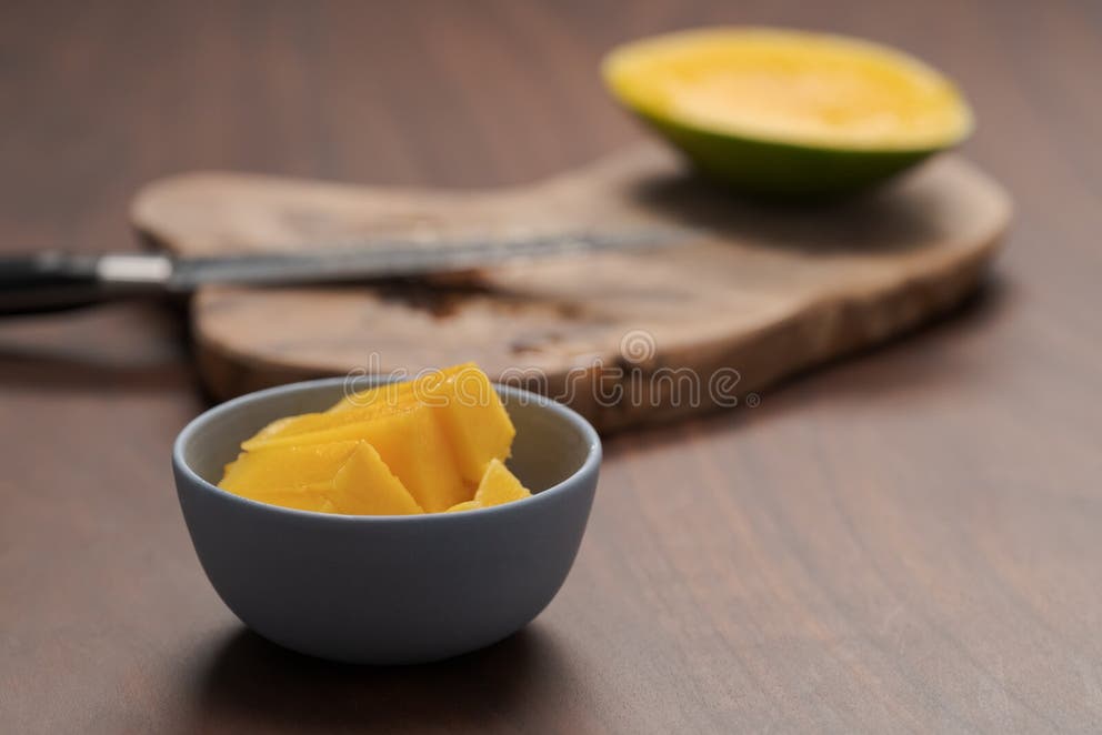 Fresh Sliced Mango in a Ceramic Bowl on Walnut Table Stock Image ...