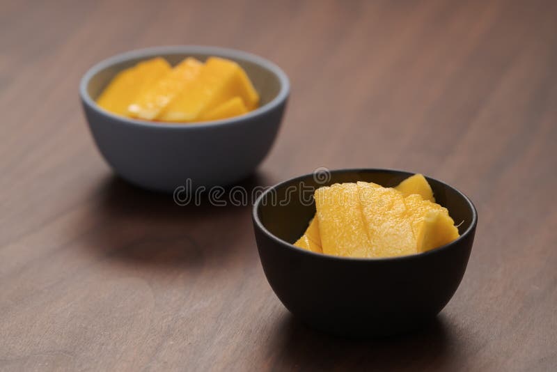 Fresh Sliced Mango in a Ceramic Bowls on Walnut Table Stock Image ...