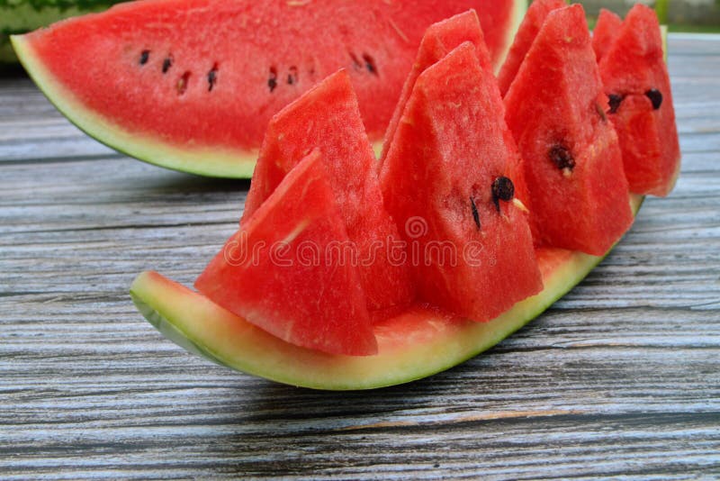 Fresh Sliced Watermelon and Watermelon Pieces on a Wooden Table. Stock ... Fresh Sliced Watermelon and Watermelon Pieces on a Wooden Table. Stock ...