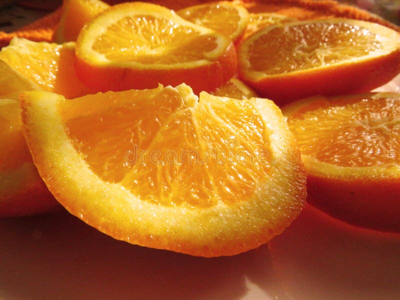 Fresh Slices of Orange Under Rays of Morning Sun. Stock Photo - Image ...