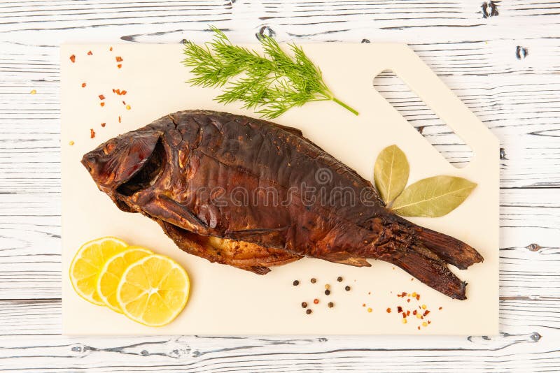 Fresh Smoked Fish Carp on a Cutting Board of Artificial Stone Stock ...