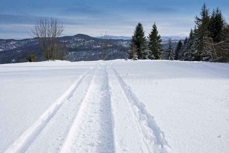 Snowmobile Trail in the Snow on a Mountain Slope Stock Image - Image of ...