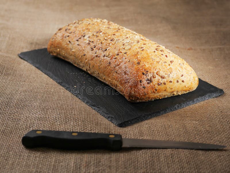 Fresh Sourdough Bread with Nuts and Small Knife on a Slate Plate and ...